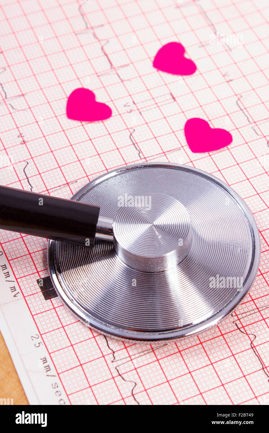 Hearts of paper and medical stethoscope lying on electrocardiogram ...
