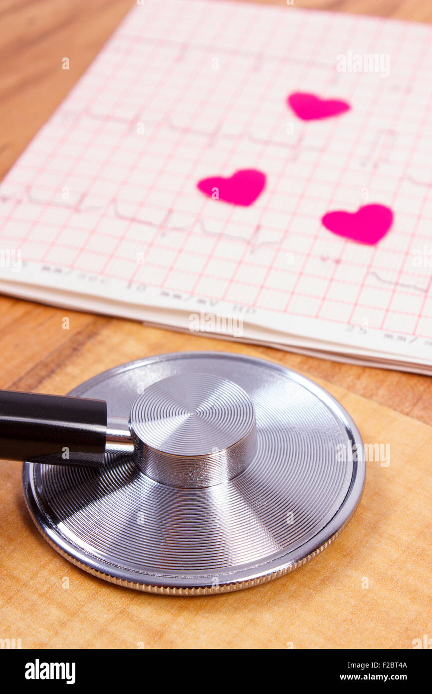 Hearts of paper and medical stethoscope lying on electrocardiogram ...