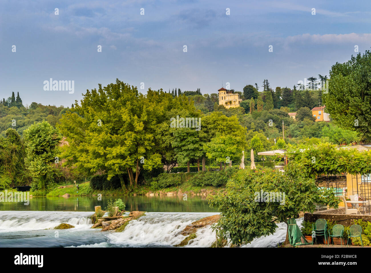 ancient buildings of a typical Italian medieval village: the river runs ...
