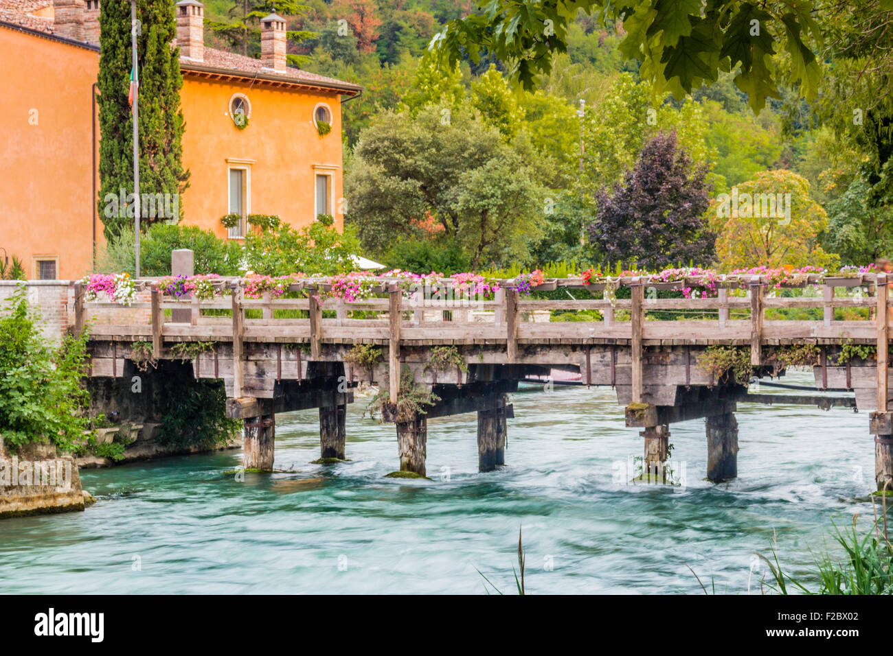 ancient buildings of a typical Italian medieval village: the river runs ...