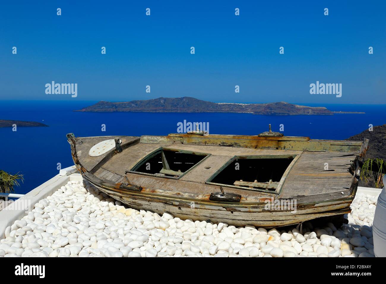 An old rowing boat on a caldera rooftop Santorini Greece Stock Photo ...