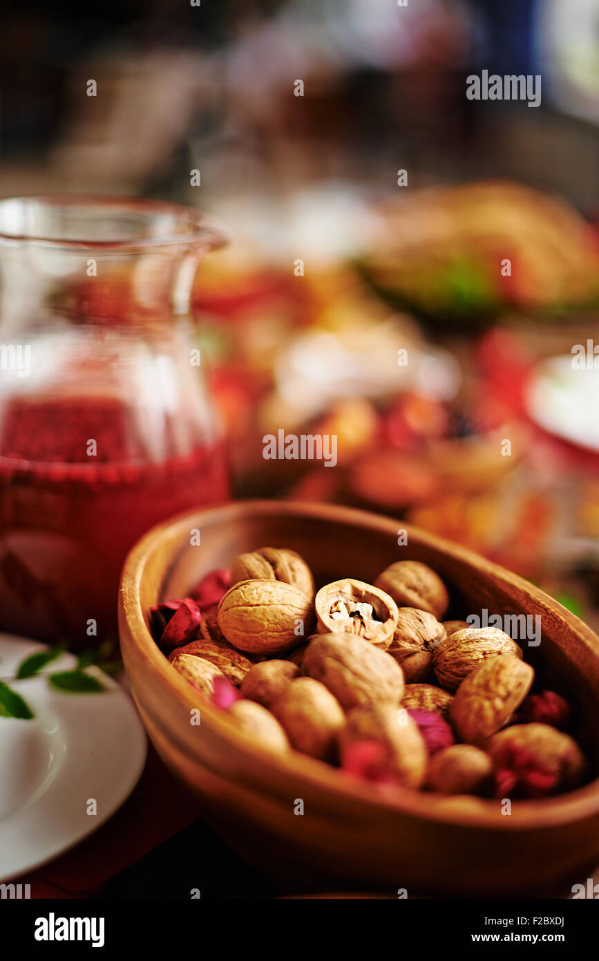 Walnuts in wooden bowl on festive table Stock Photo - Alamy