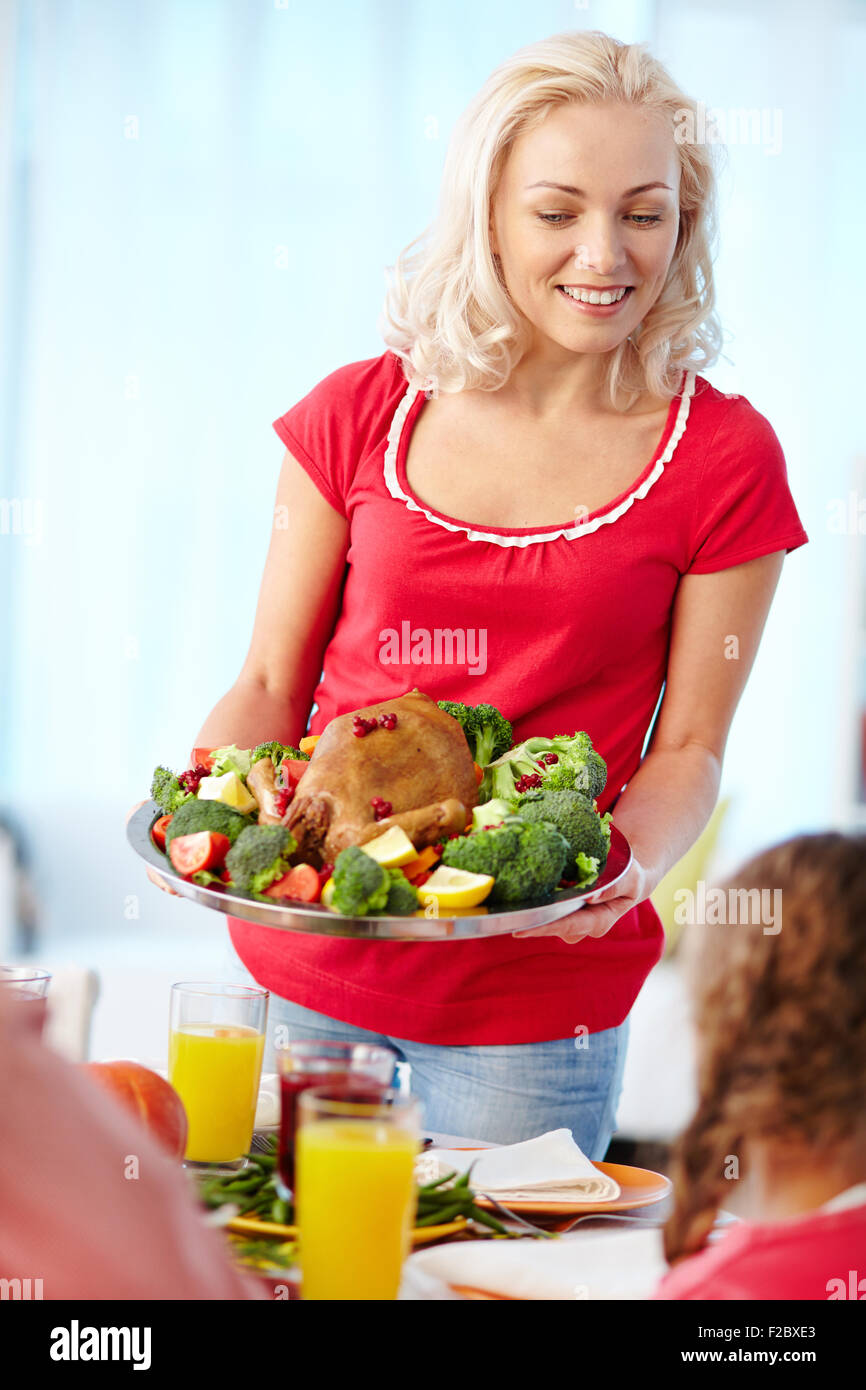 Happy young woman with roasted Thanksgiving turkey Stock Photo - Alamy