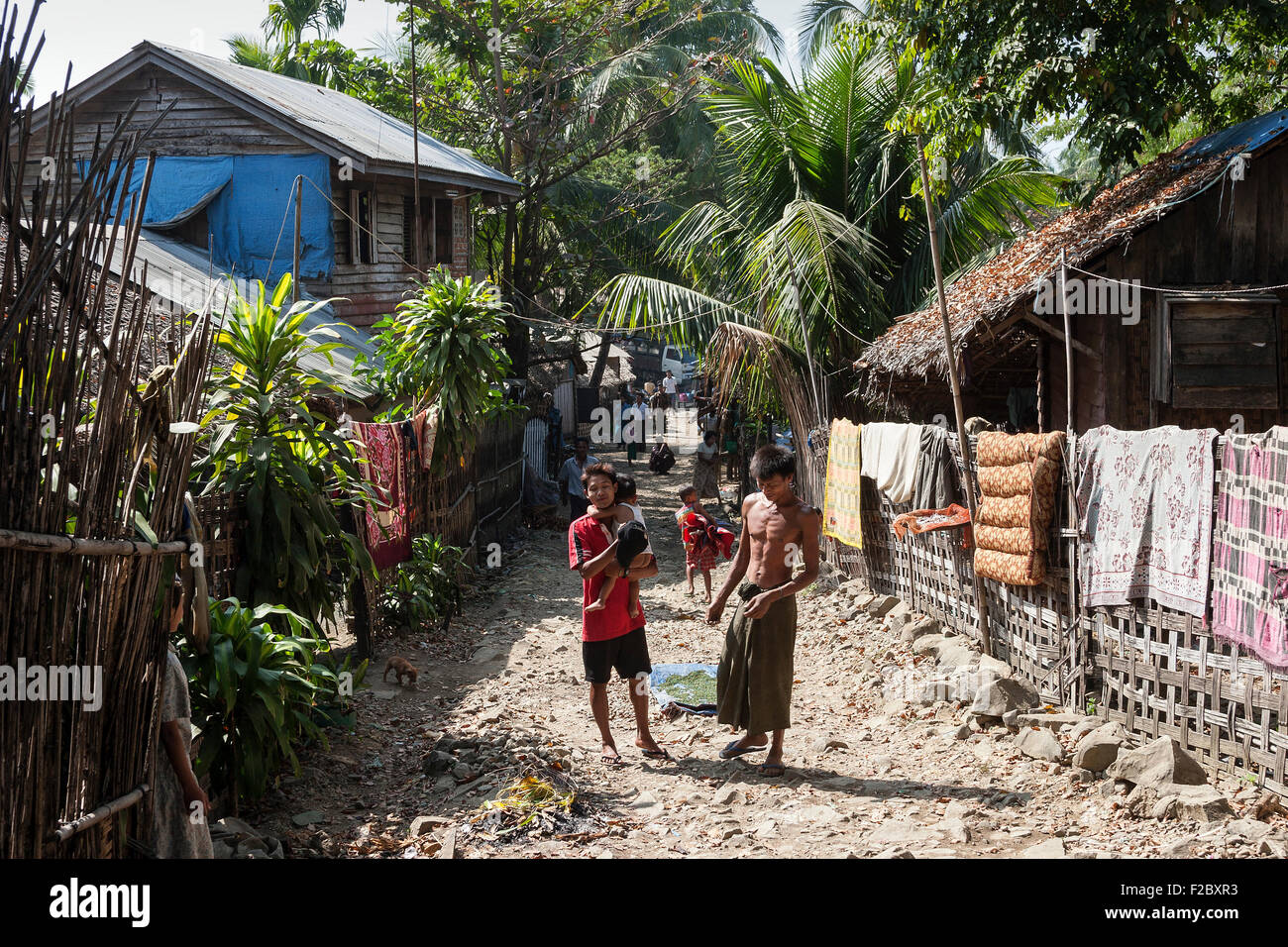 Village scene, path between the wooden houses, Ngapali, Thandwe ...