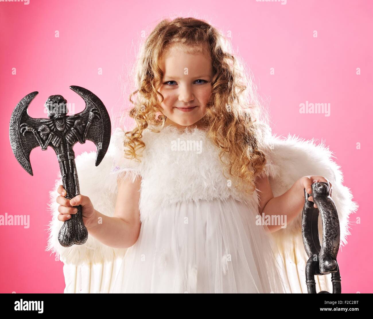 Beautiful little angel with an axe Stock Photo - Alamy