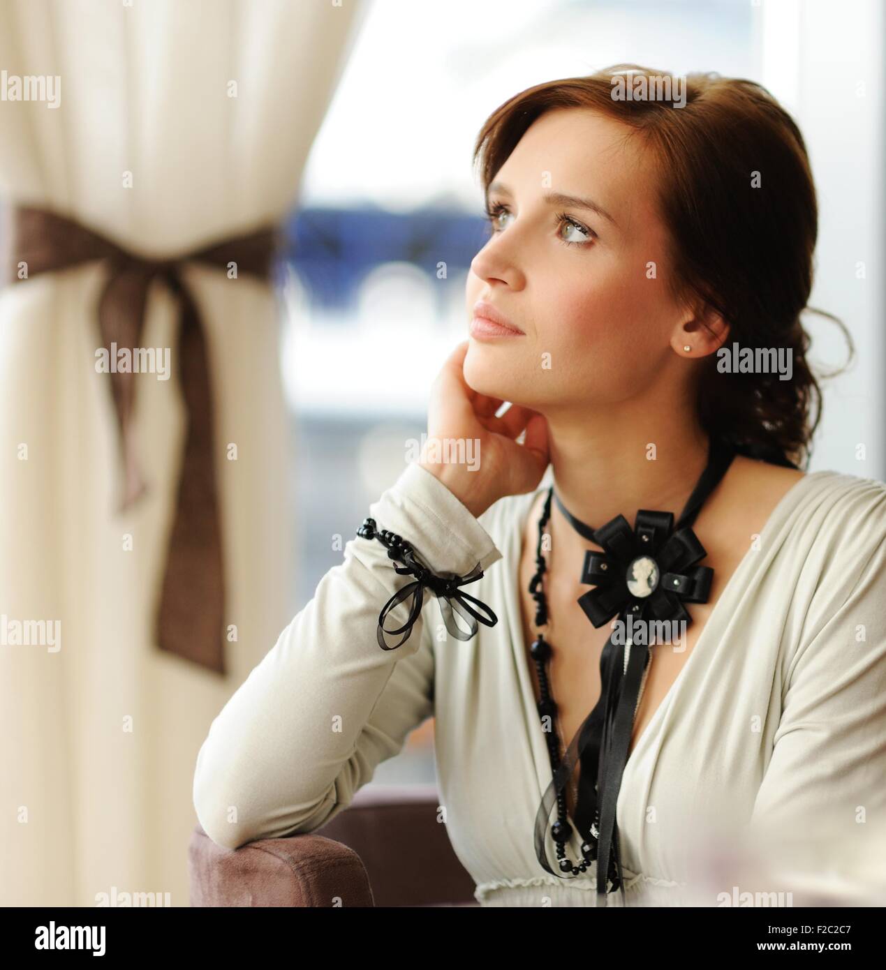 Beautiful thinking brunette woman Stock Photo - Alamy