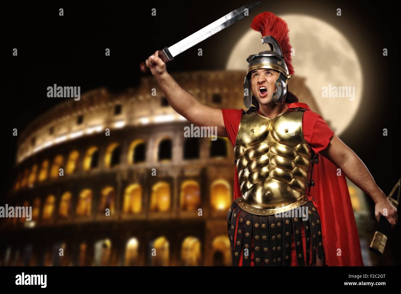 Roman legionary soldier in front of coliseum at night time Stock Photo ...