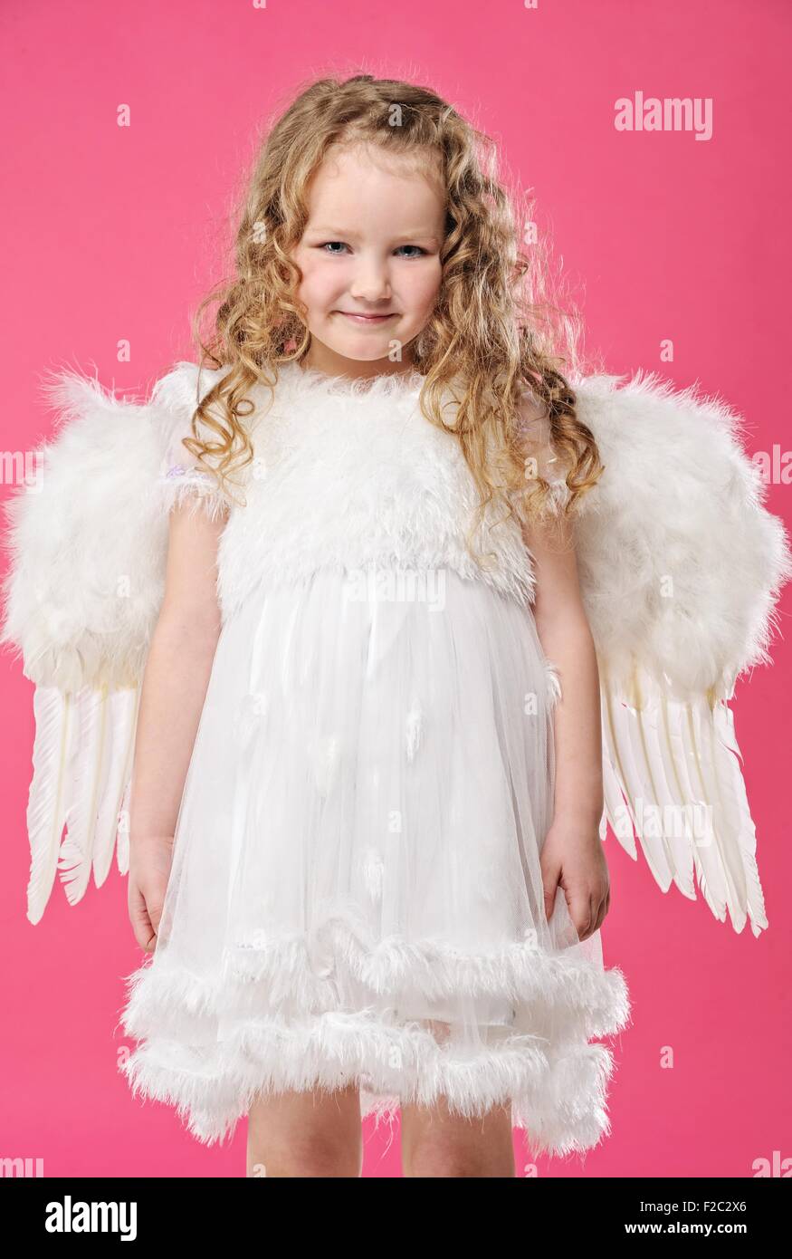 Beautiful little angel girl isolated on pink background Stock Photo - Alamy