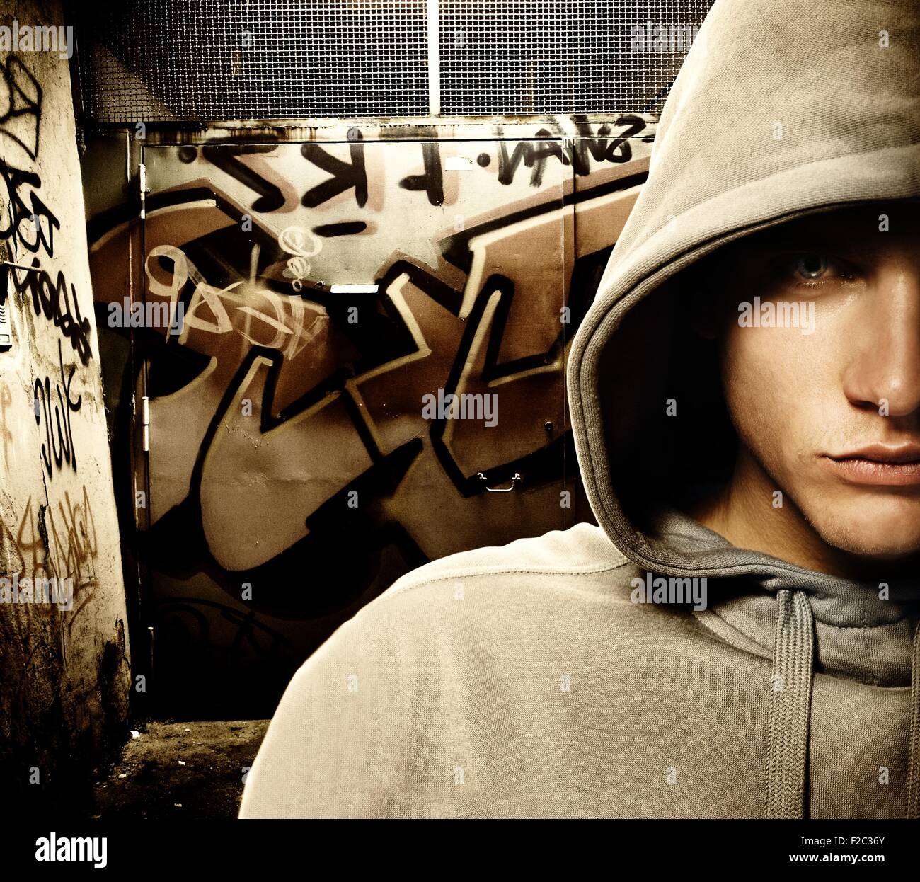 Cool looking hooligan in a graffiti painted gateway Stock Photo - Alamy