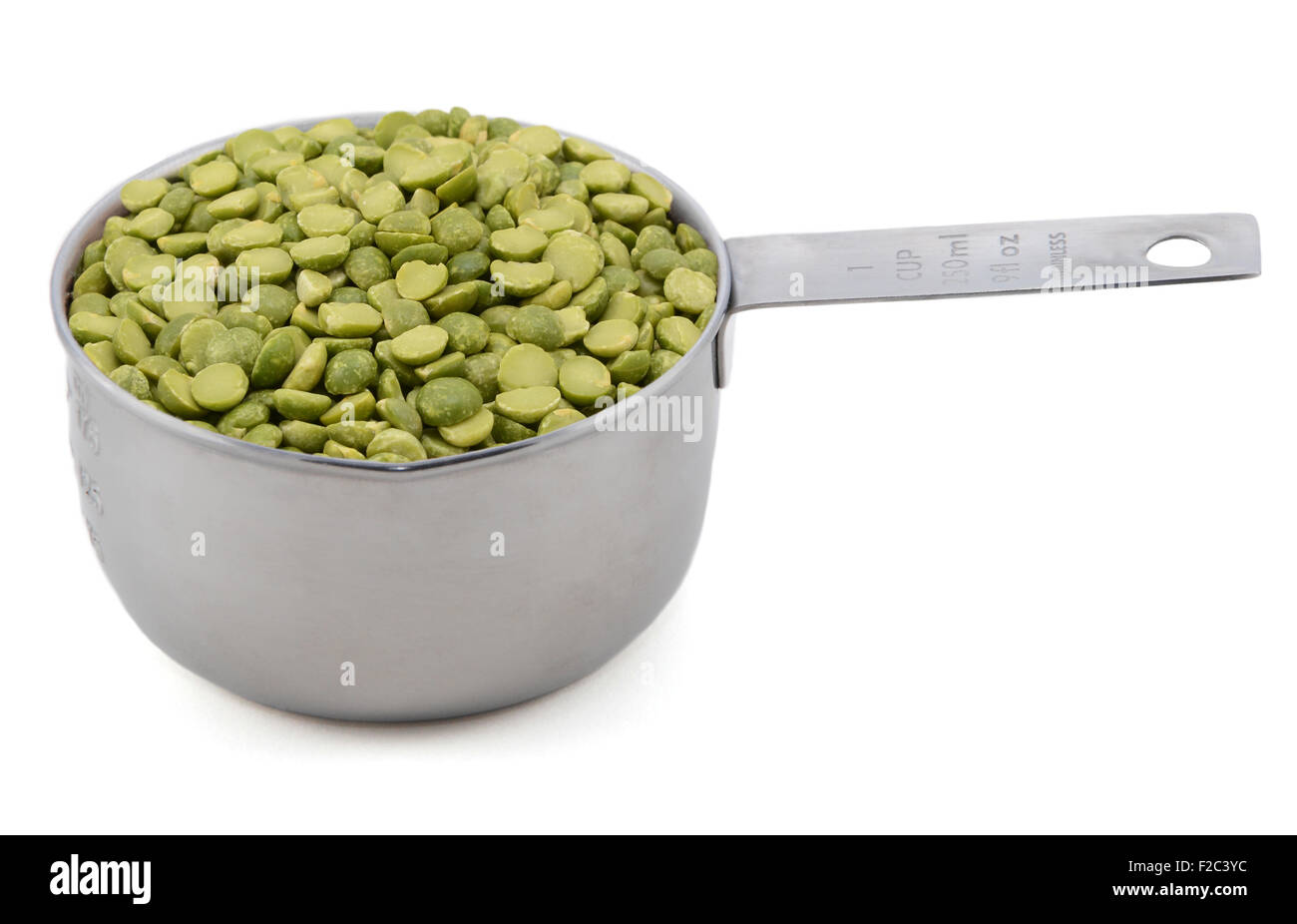 Green split peas in an American measuring cup, isolated on a white ...