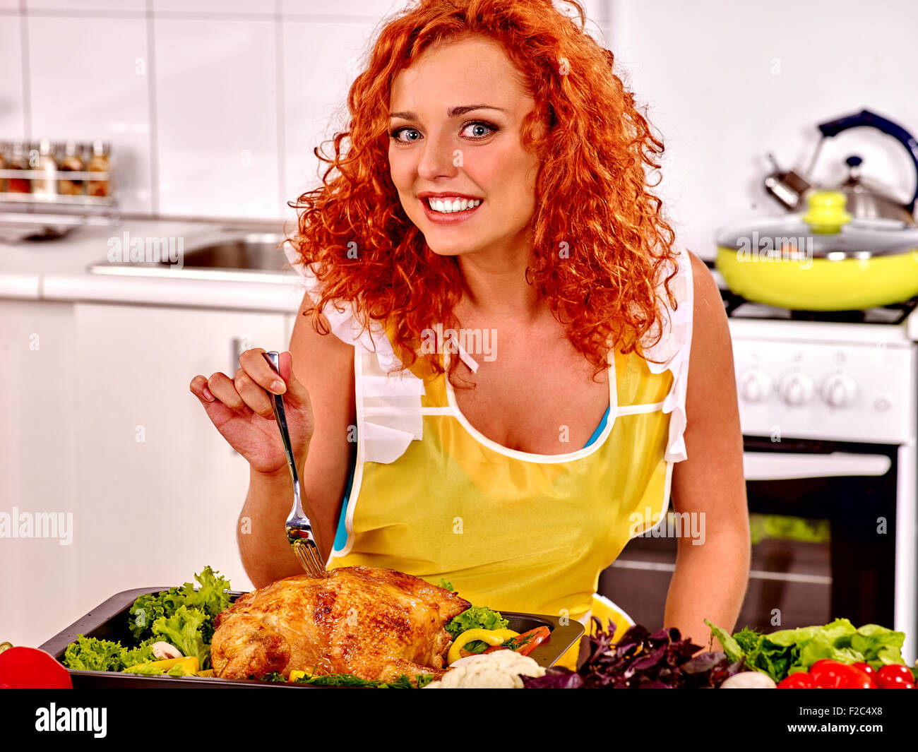 Woman cooking chicken at kitchen Stock Photo - Alamy