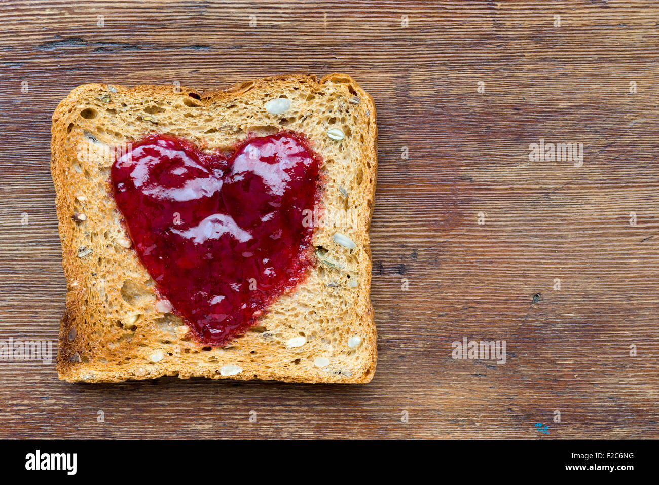 toast with red jam in shape of heart on vintage wooden background Stock ...