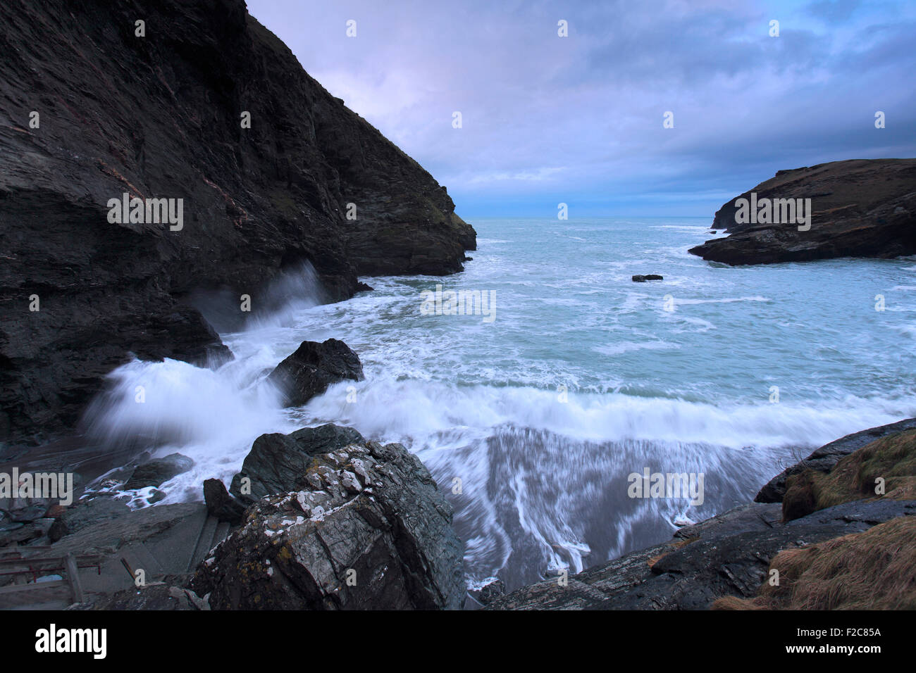 Dusk colours over the shore at Tintagel beach, Tintagel town, Cornwall ...