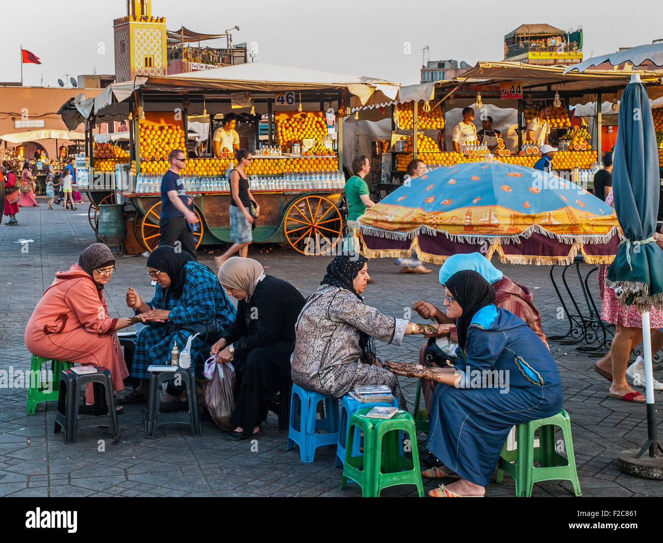 Women giving henna tattoos in Djemaa el Fna, the large square in the ...