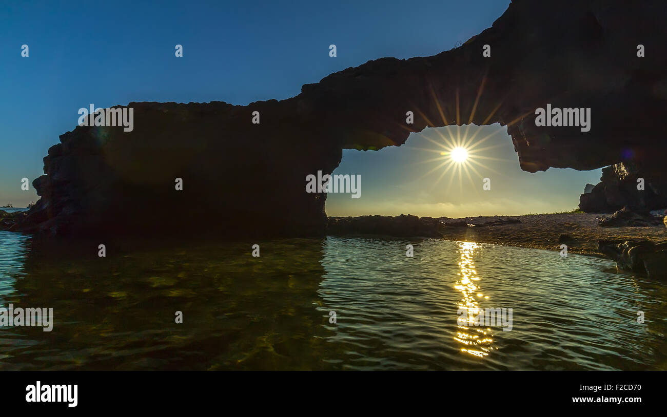 Sunrise on massive stone gate arch Stock Photo - Alamy