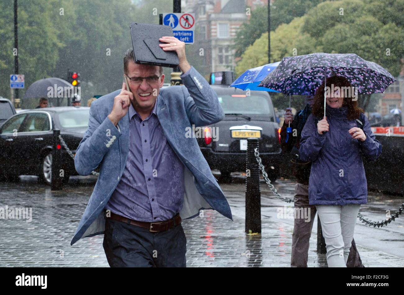 London, UK, 16 September 2015. Heavy rain outside the Houses of ...
