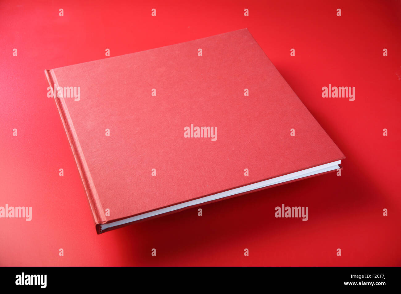 closed red book on the matt red background Stock Photo - Alamy