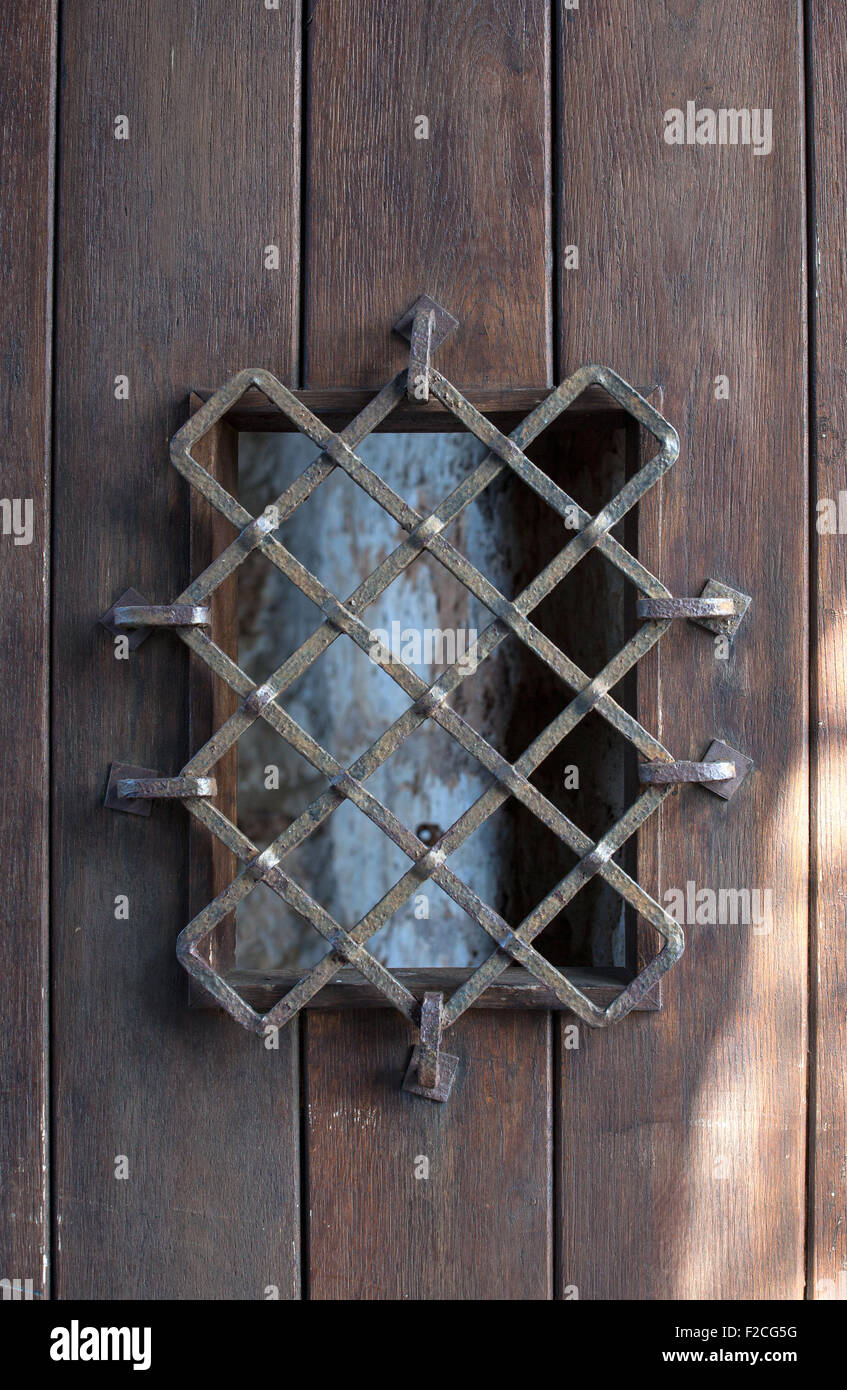 Close-up fragment of ancient door with grate Stock Photo - Alamy