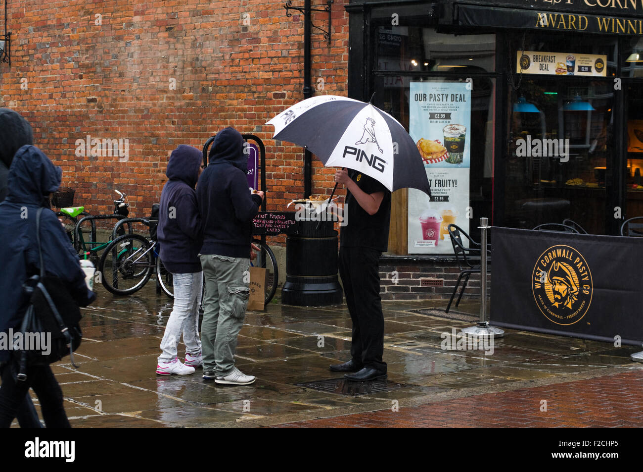 Chichester, West Sussex, England. Two people sample food on the high ...