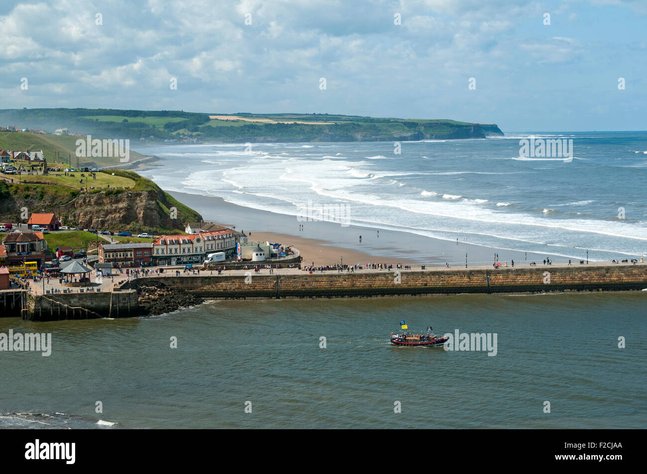 The west pier of Whitby Harbour with Sandsend Bay beyond. From the ...