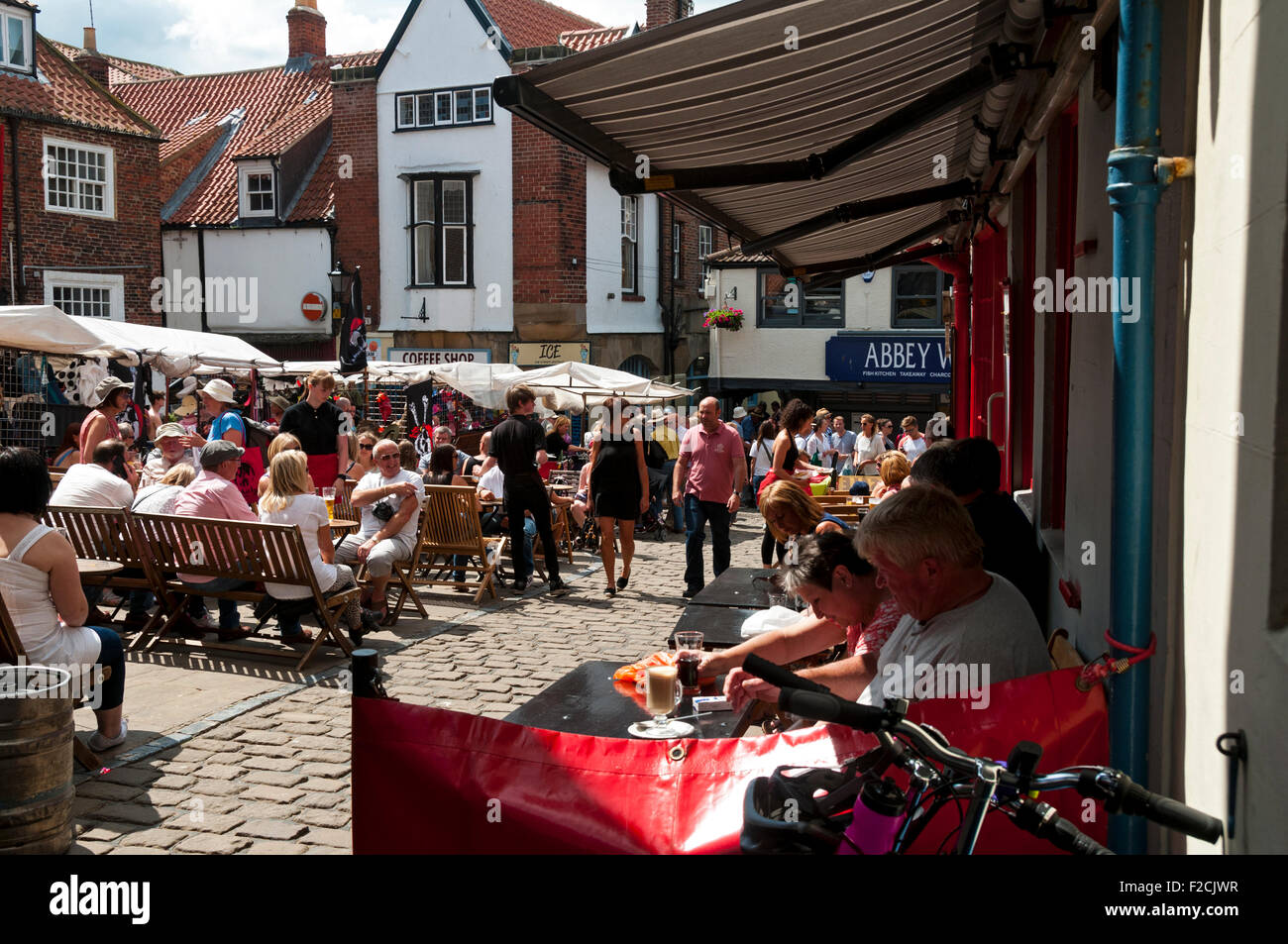 Market stalls and café in the Market Place, Whitby, Yorkshire, England ...