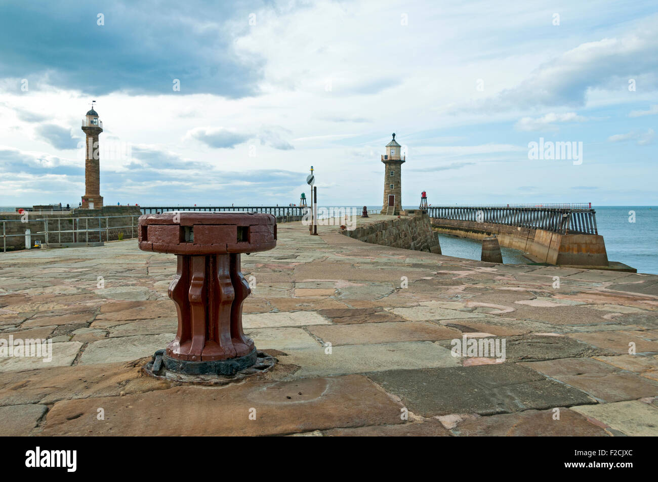 Old capstan and lighthouses from the East Pier of Whitby Harbour ...