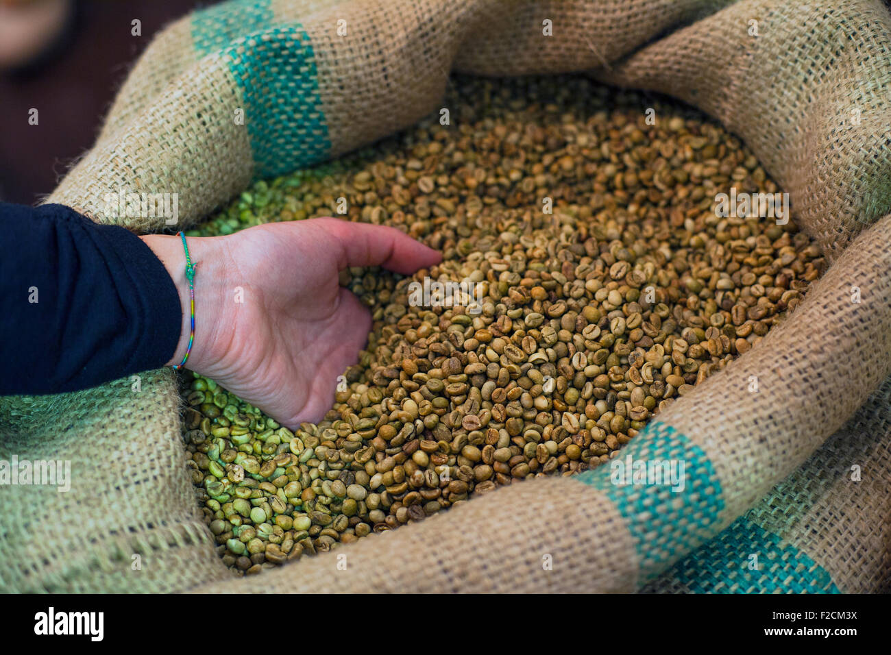 Hand touching coffee beans inside the jute bag Stock Photo - Alamy