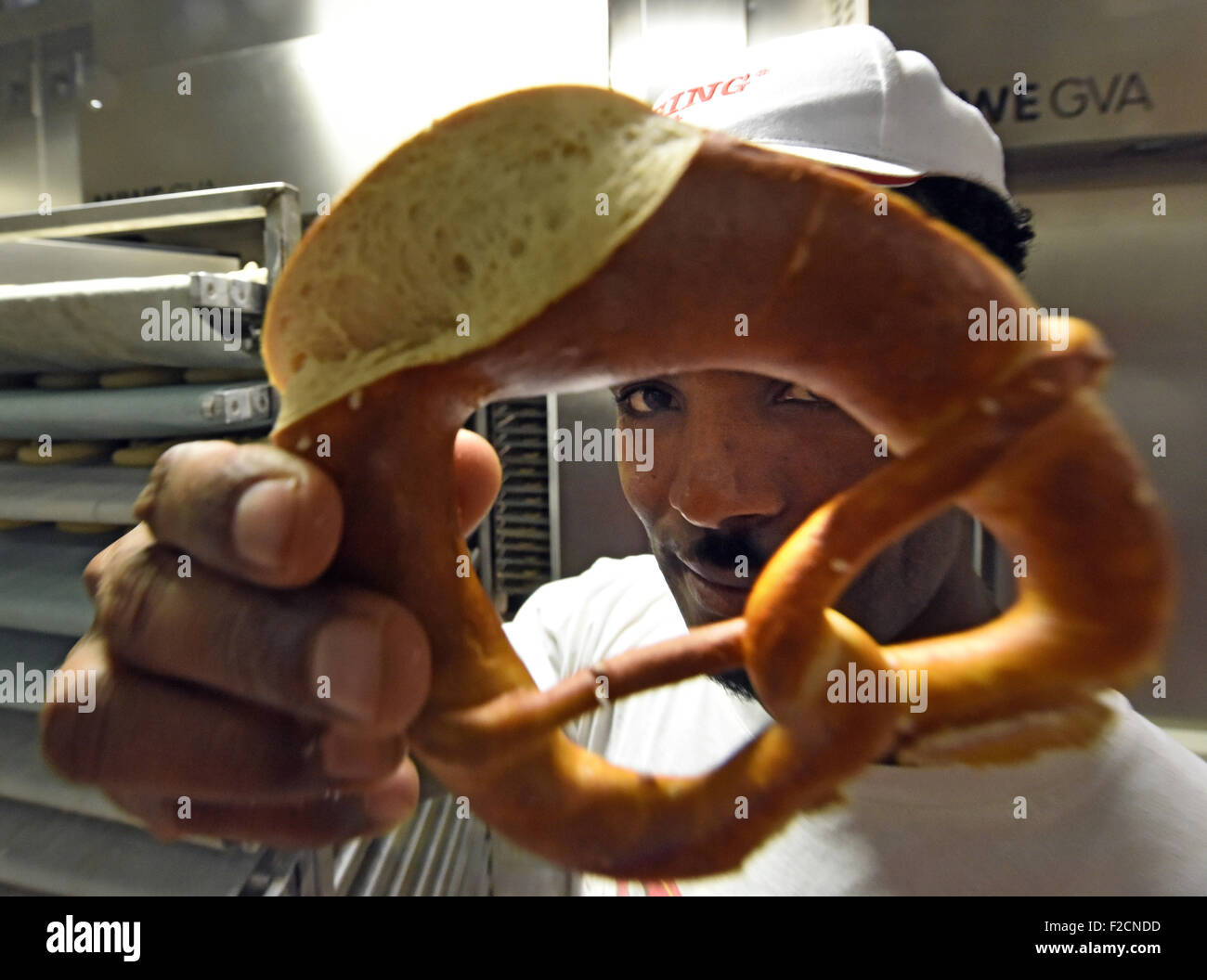 Baker in training Ghebru Aregay (l) trys a German Brezel at a bakery in ...