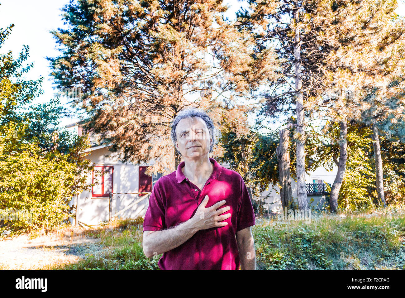 Forty years adult holding his hand over heart Stock Photo - Alamy