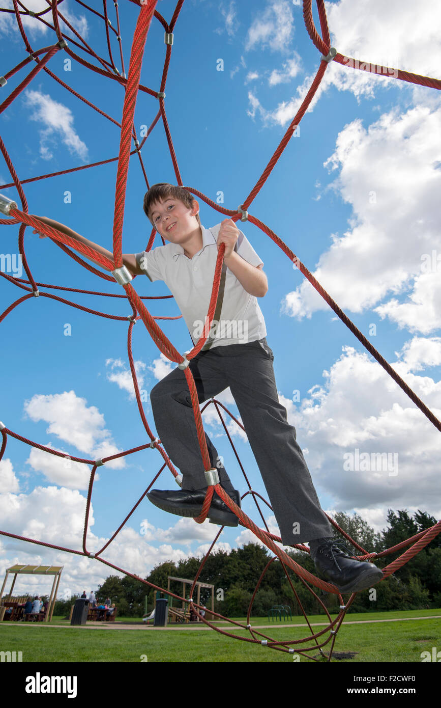 Boy climbing rope frame Stock Photo - Alamy