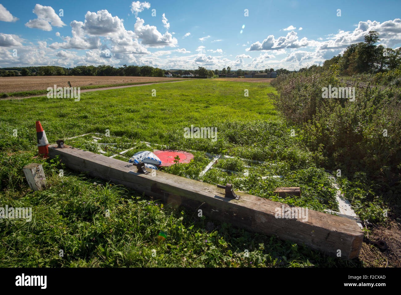 Train crossing broken gate lying in field Stock Photo - Alamy