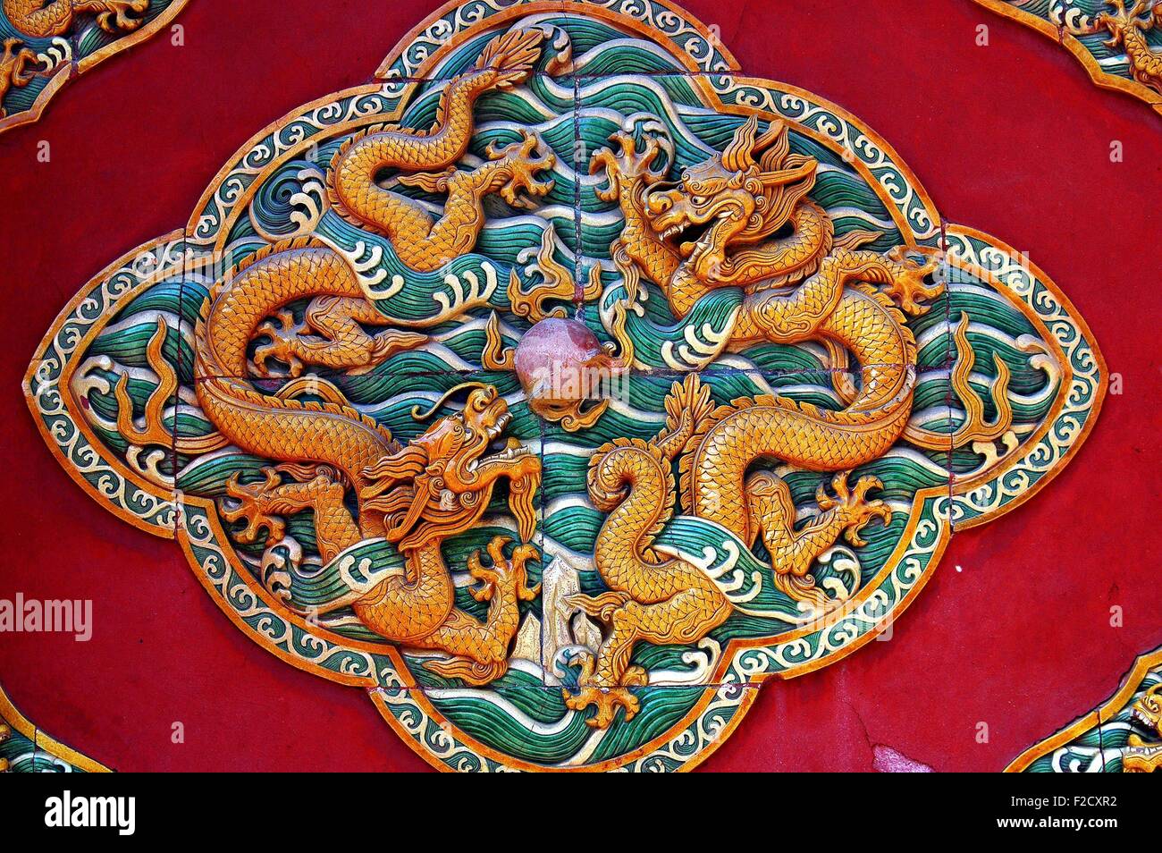 Beijing, China: A bas relief panel of glazed dragons on a wall at the ...