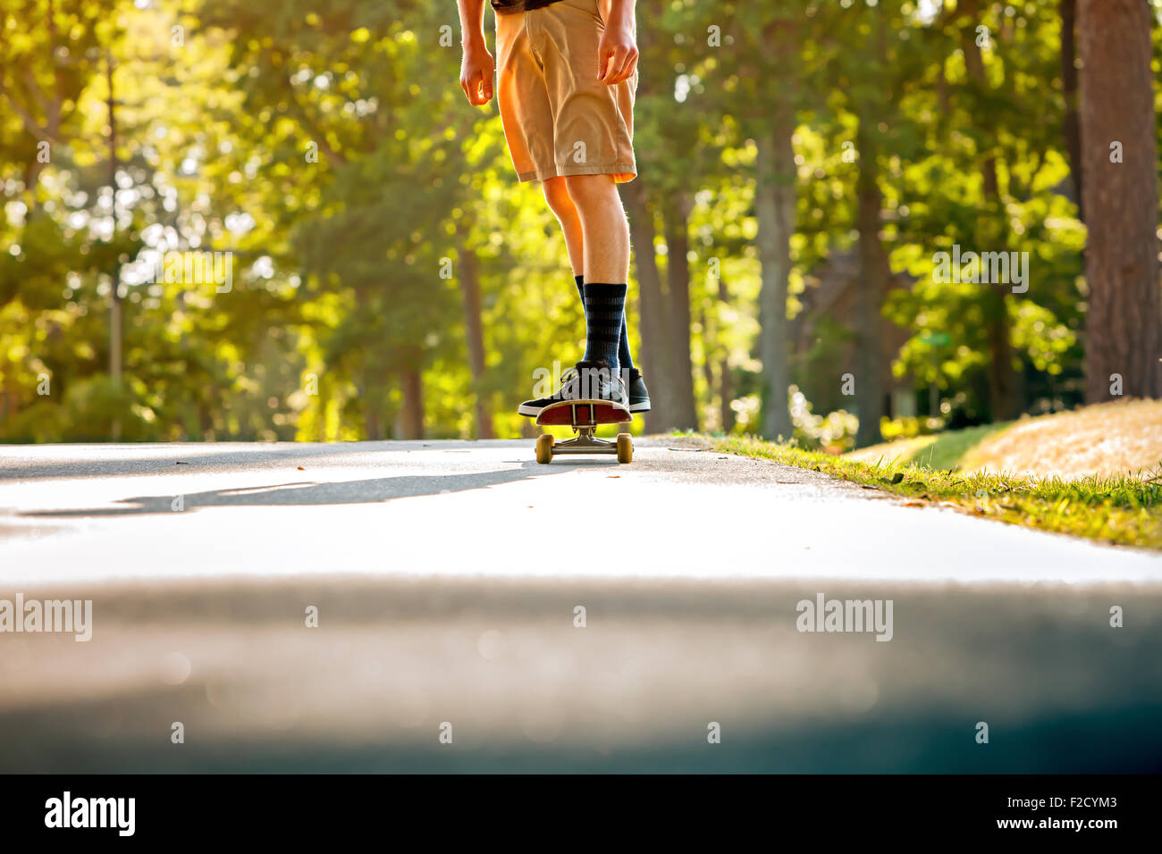 A boy skateboarding outside on a warm summer day Stock Photo - Alamy