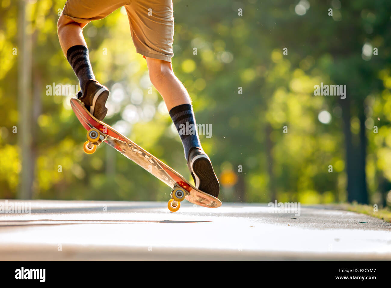 A boy skateboarding outside on a warm summer day Stock Photo - Alamy