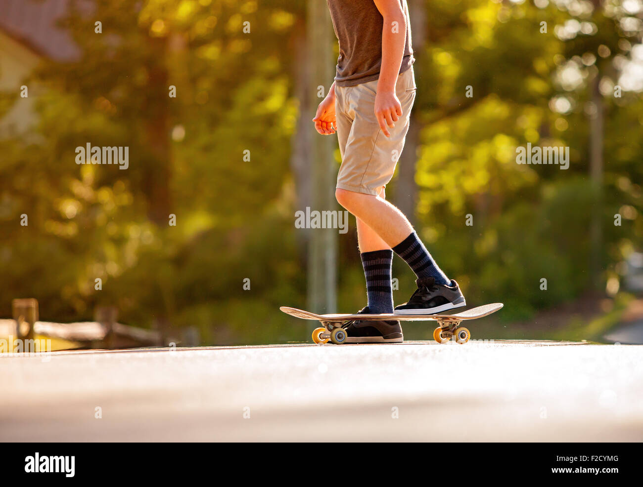 A boy skateboarding outside on a warm summer day Stock Photo - Alamy
