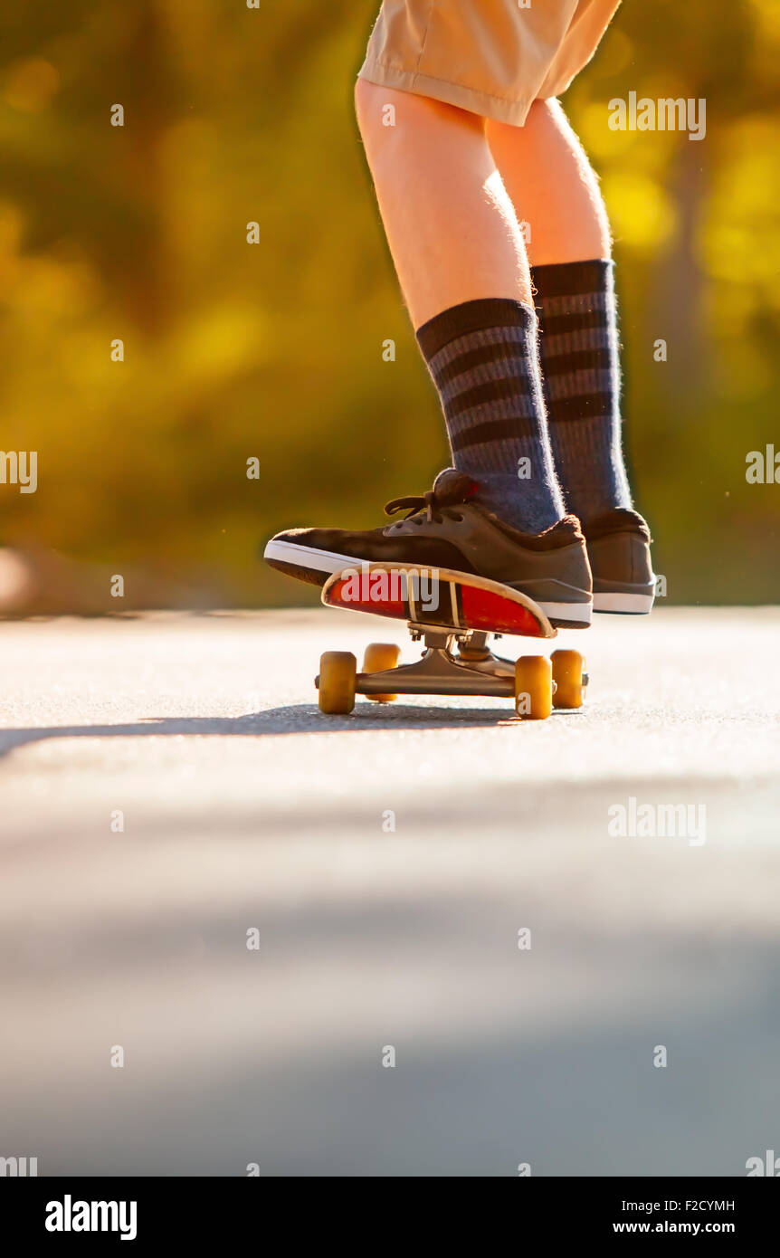 A boy skateboarding outside on a warm summer day Stock Photo - Alamy