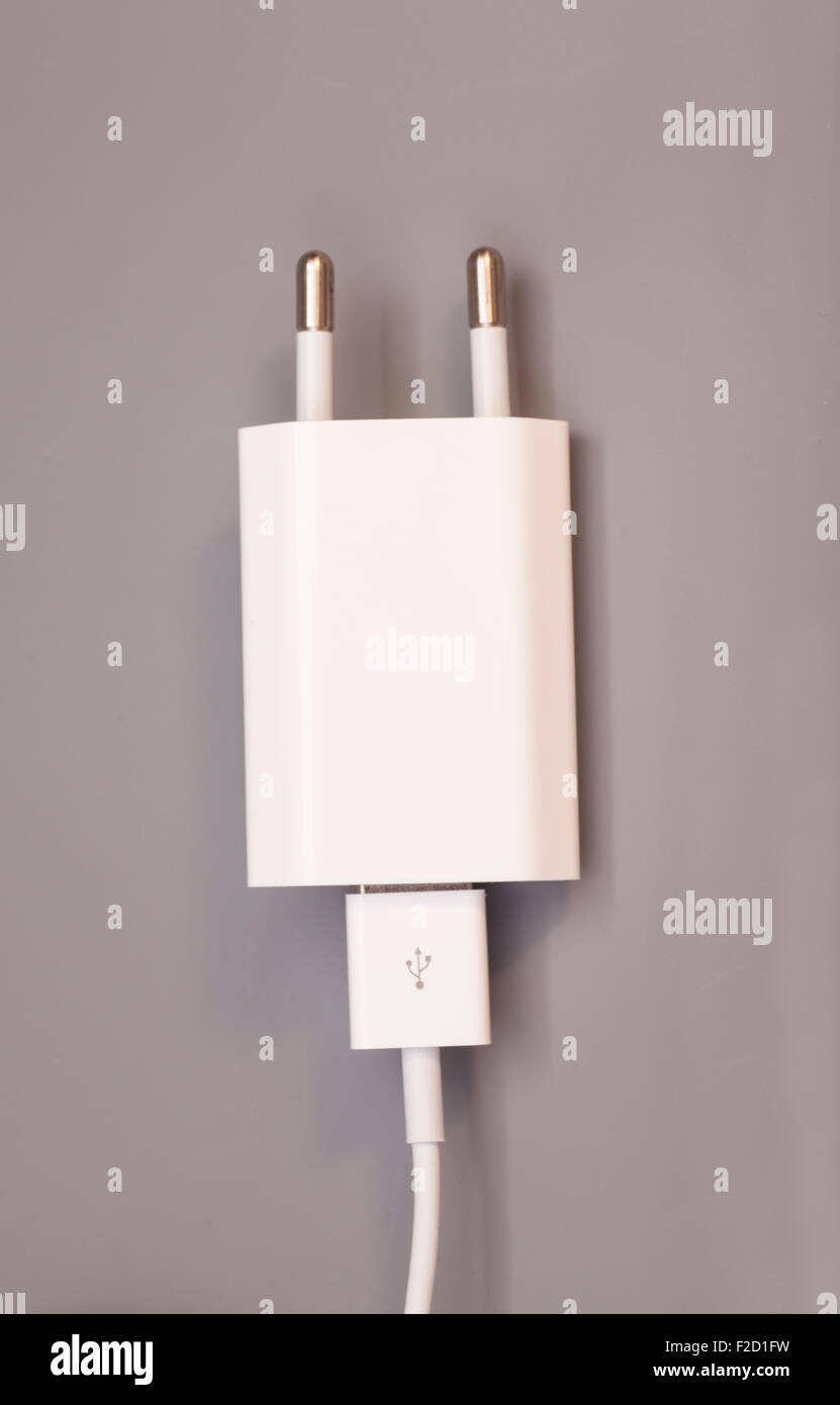 Electrical adapter to USB port on gray background Stock Photo - Alamy