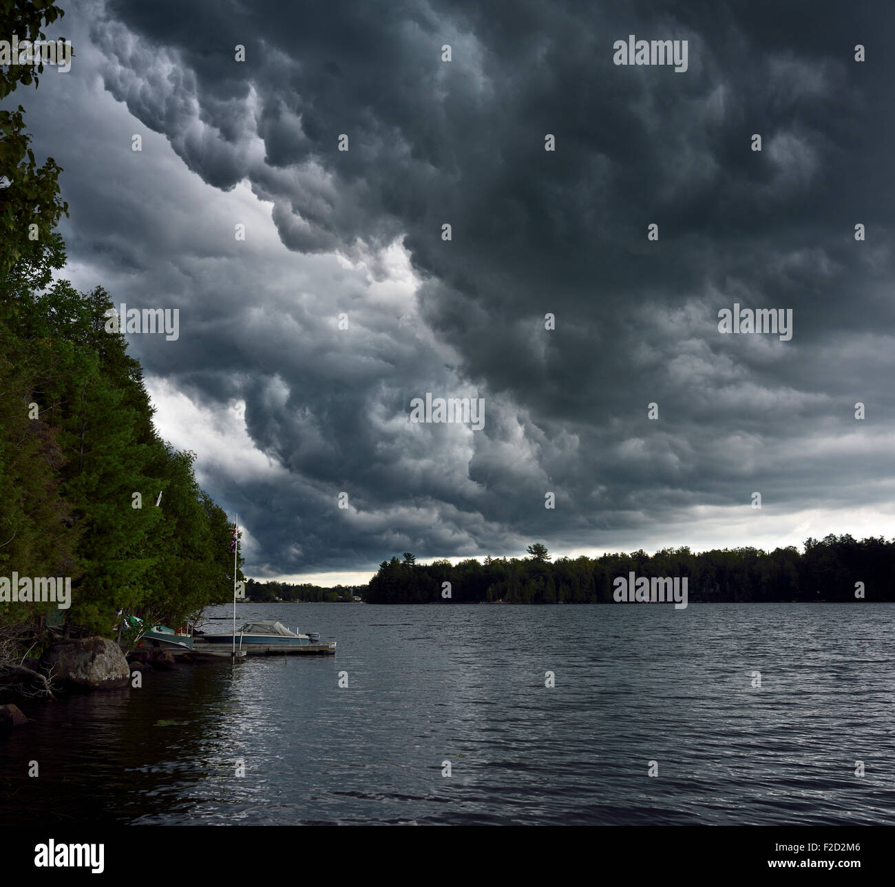 Swirling dark clouds before a thunderstorm over Lake Cecebe in cottage ...
