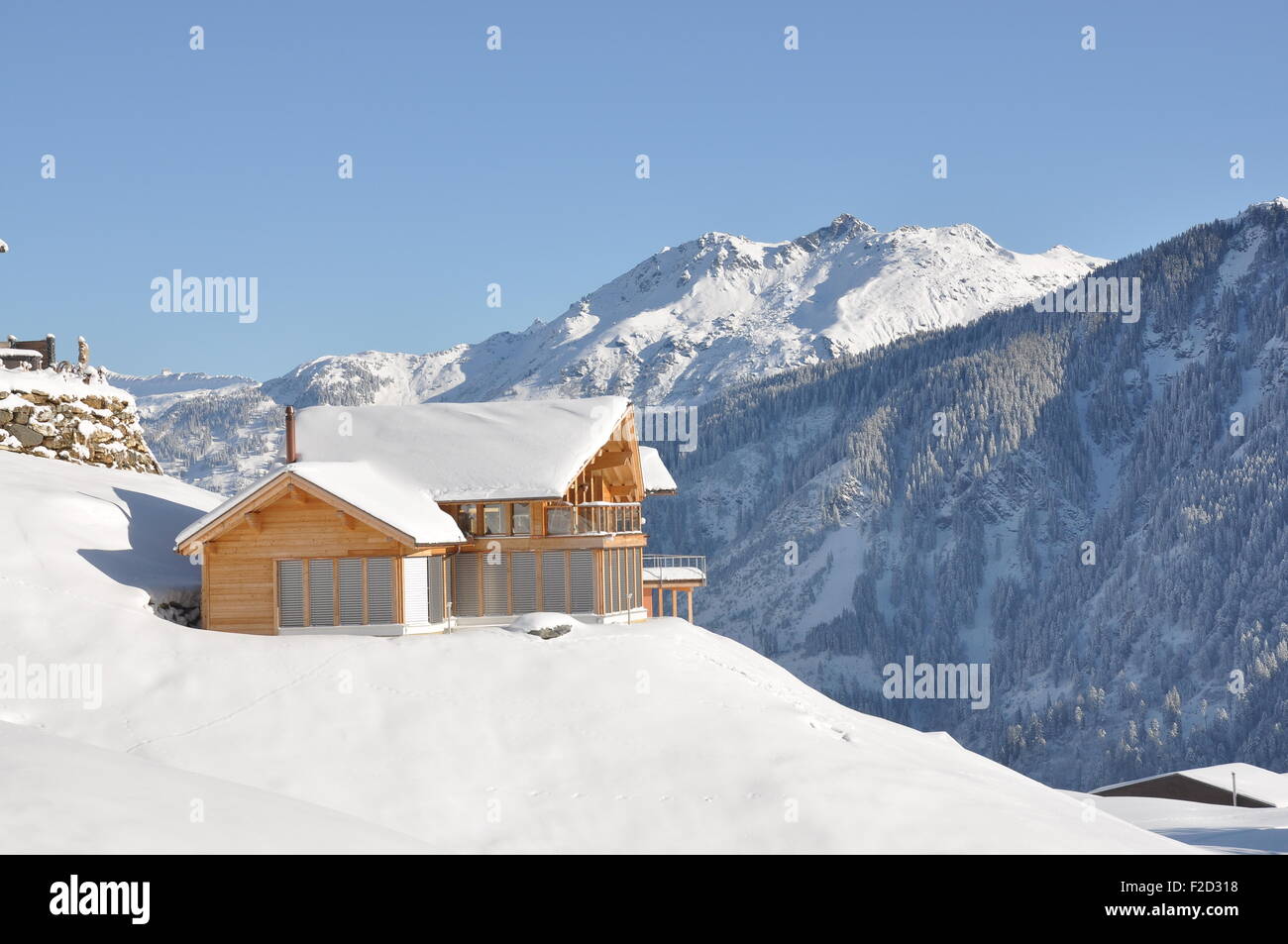 Holiday cottage against snowy Alps. Braunwald, Switzerland Stock Photo ...