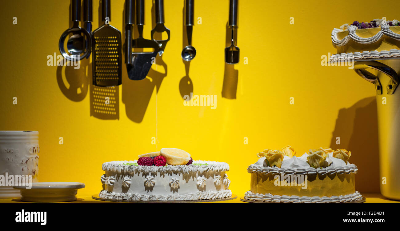 Cake in the kitchen on yellow background Stock Photo - Alamy