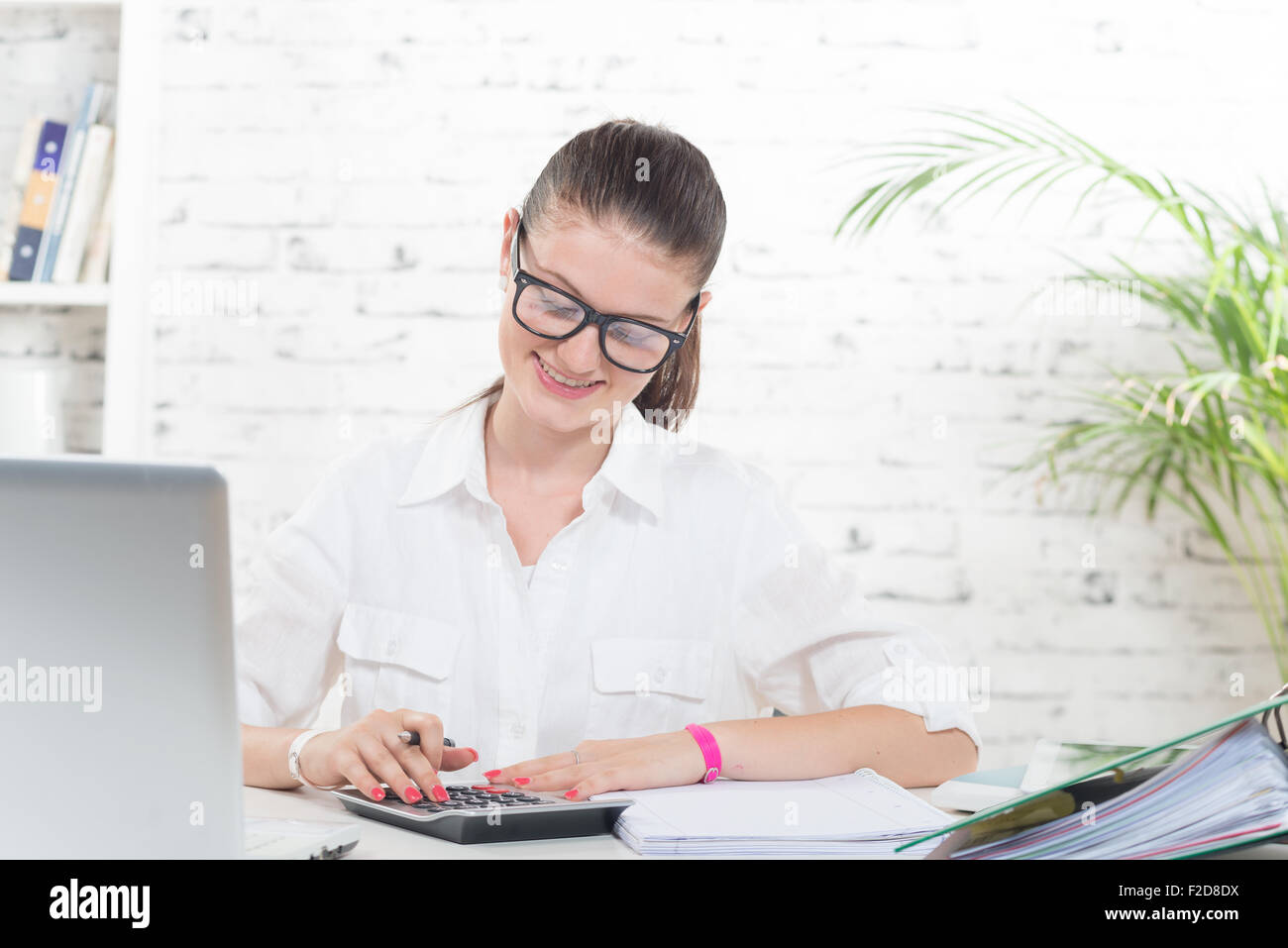 A young secretary working in her office Stock Photo - Alamy