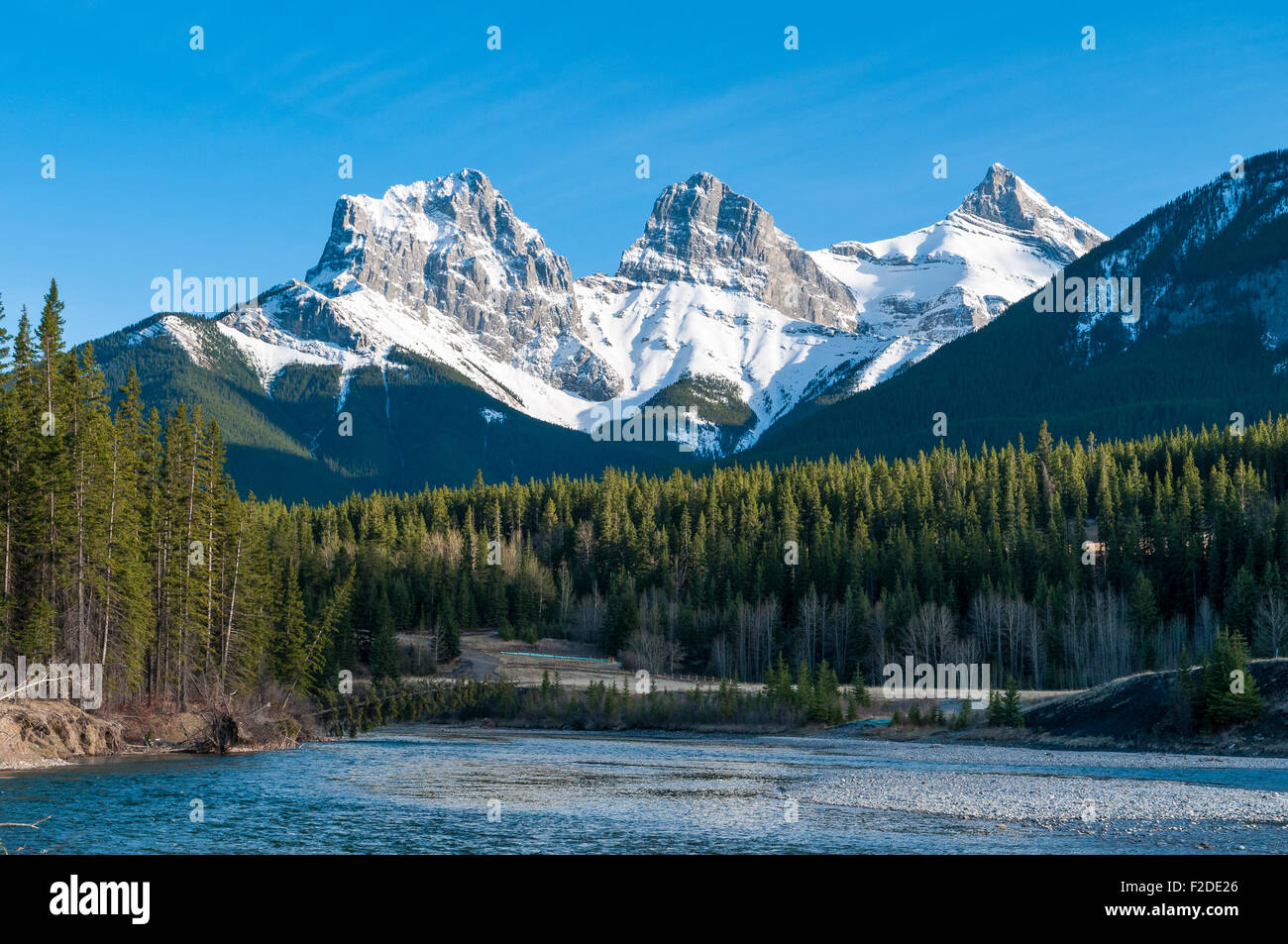 The Three Sisters, mountain peaks. The Bow River, Canmore, Alberta ...