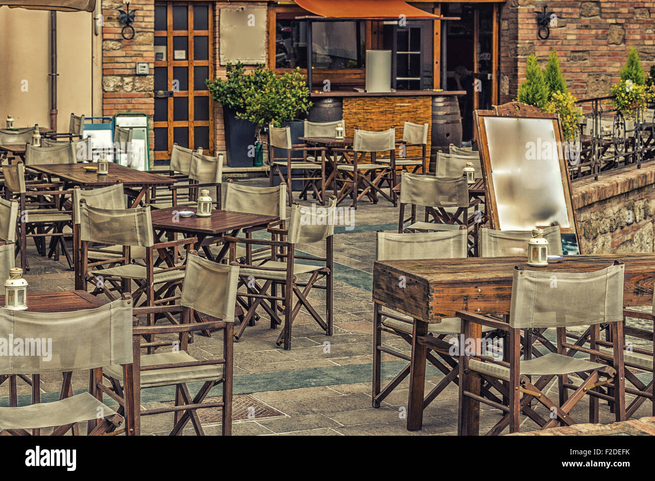 tables of a typical street bar in a medieval village in the countryside ...