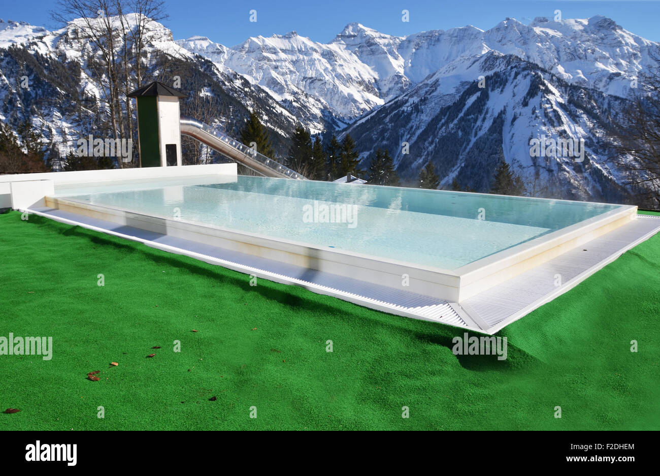 Swimming pool agains snowy Alps Stock Photo - Alamy