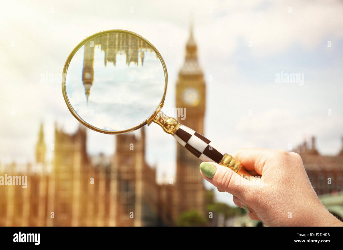 Magnifying glass in the hand against Big Ben in London Stock Photo - Alamy