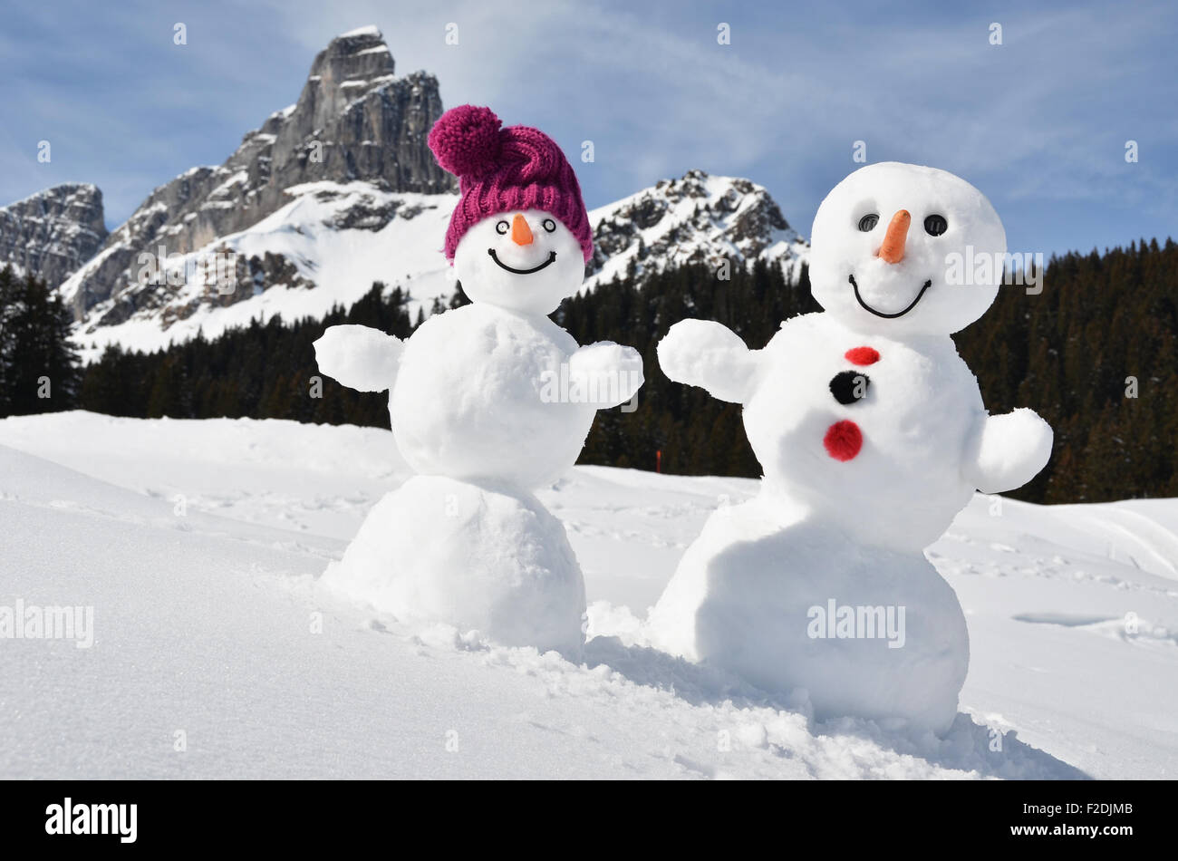 Funny snowmen against Swiss Alps Stock Photo - Alamy