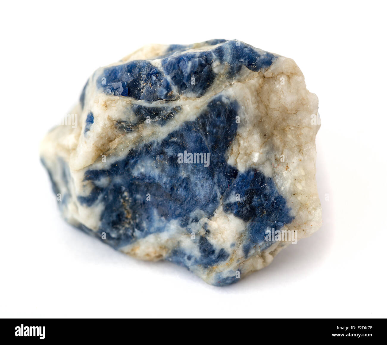 Raw sodalite stone isolated on white background Stock Photo - Alamy