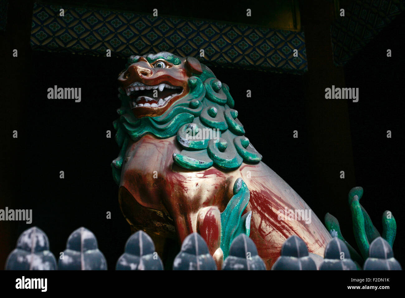 Green gold red shrine temple guardian dog Stock Photo - Alamy