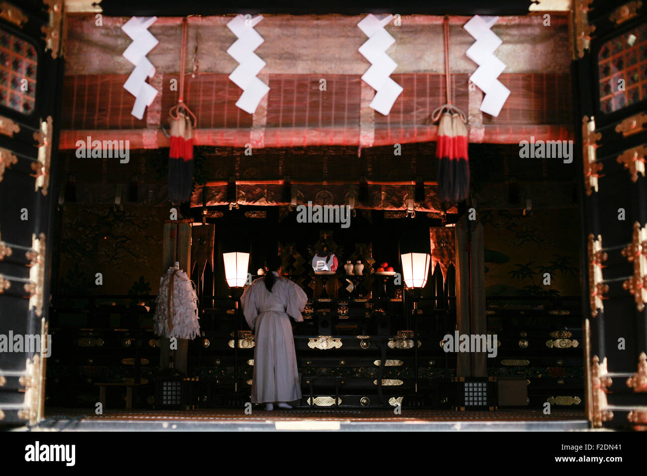 Priestess at altar in shrine Stock Photo - Alamy
