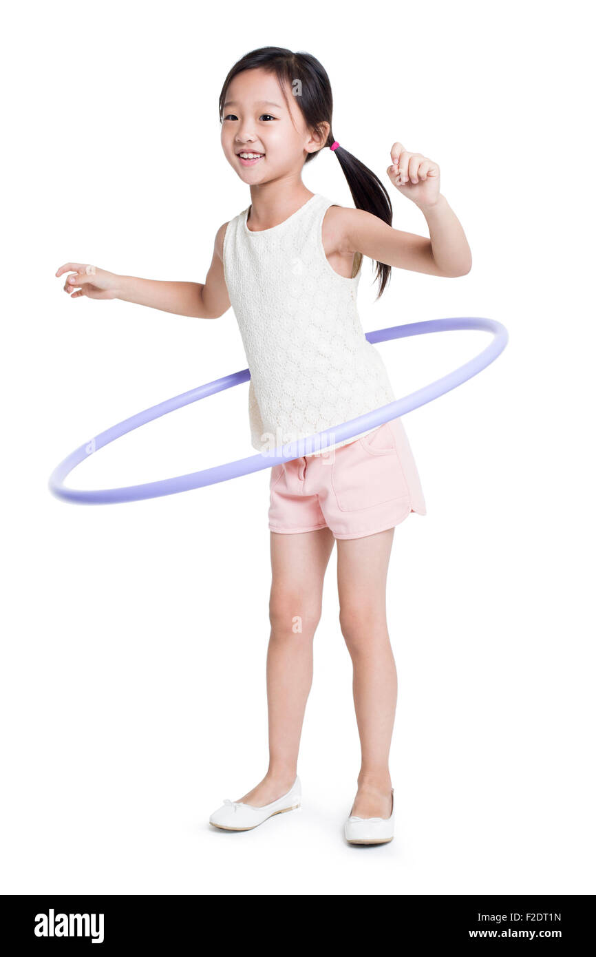 Happy girl spinning plastic hoop Stock Photo - Alamy